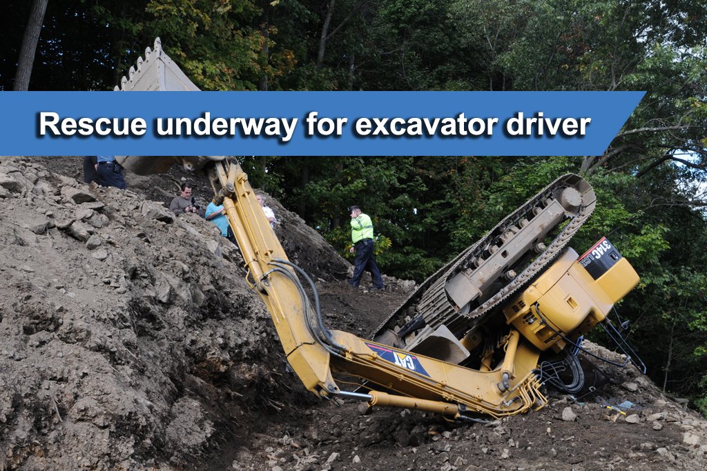 Rescue efforts underway for driver in tipped excavator
