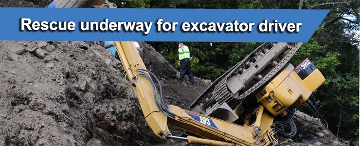 Rescue efforts underway for driver in tipped excavator